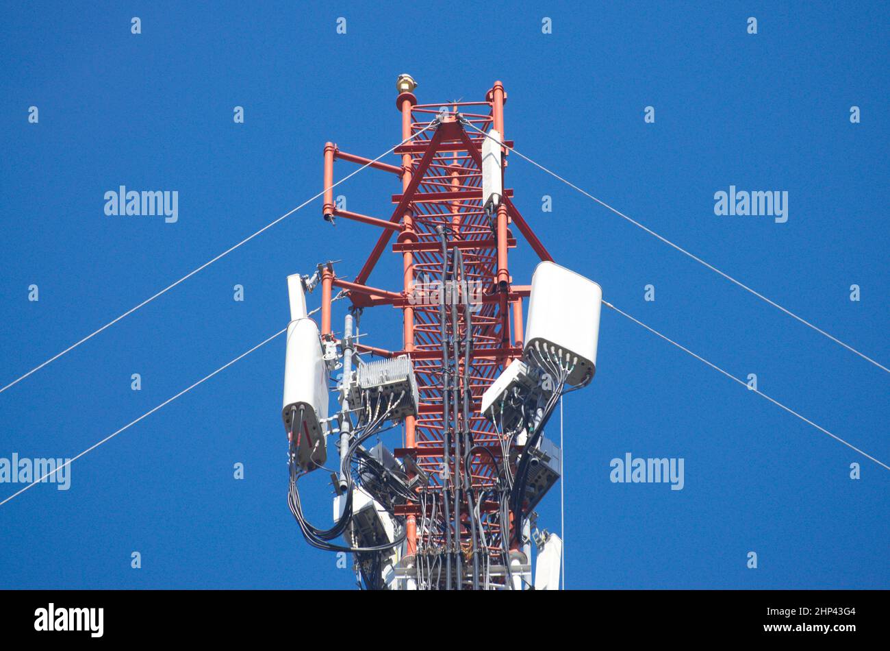 Internet towers and transmission equipment on clean blue sky background ...
