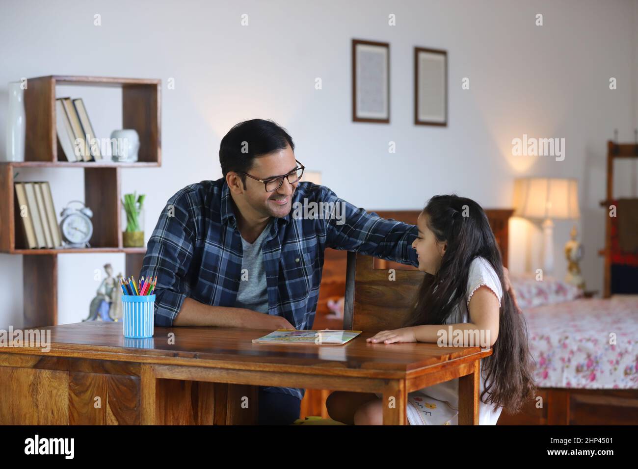Indian father and her young daughter - studying at home, doing school home work Stock Photo - Alamy