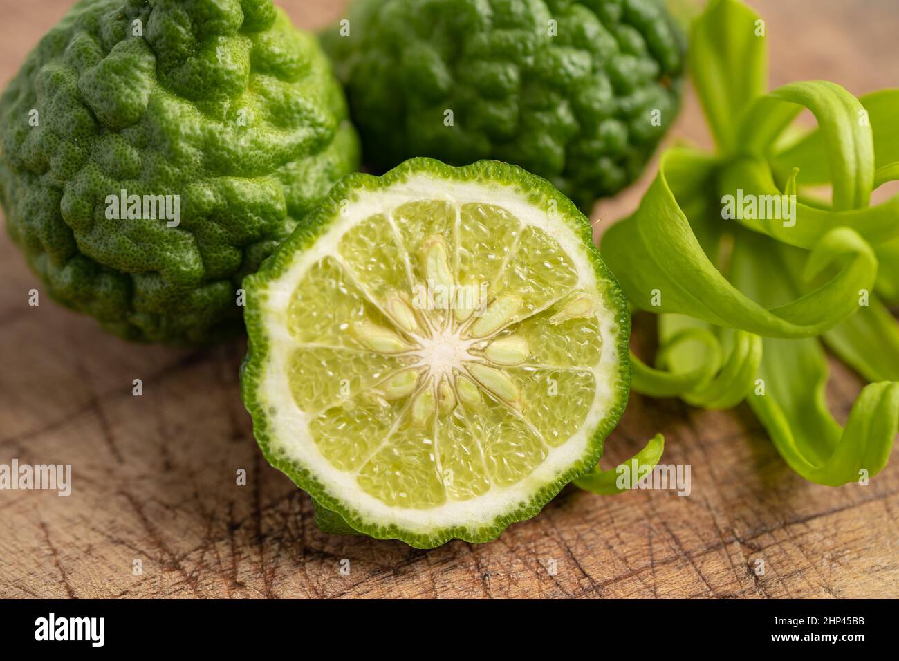 Fresh bergamot fruit with cut in half on wooden background Stock Photo ...