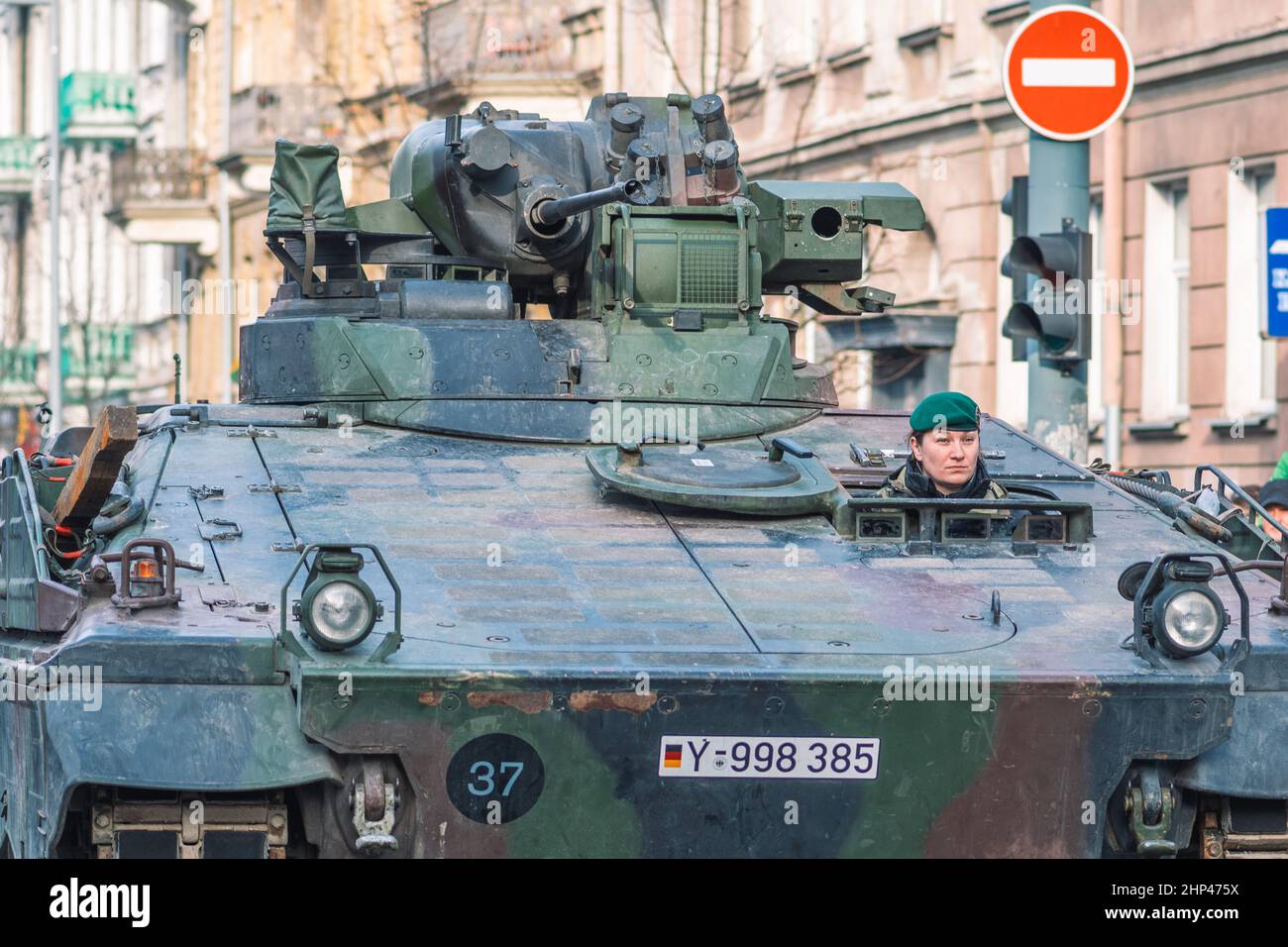 Armored crawler tank with cannon and female soldier driving in the city ...