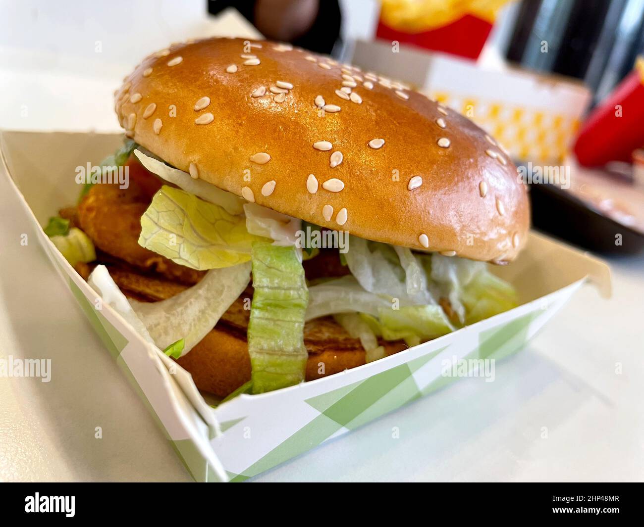 Big juicy burger with lots of vegetables packed in a box Stock Photo ...