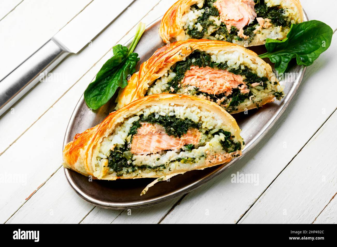 Appetizing fish pie made from salmon fish, rice and spinach. Red fish ...