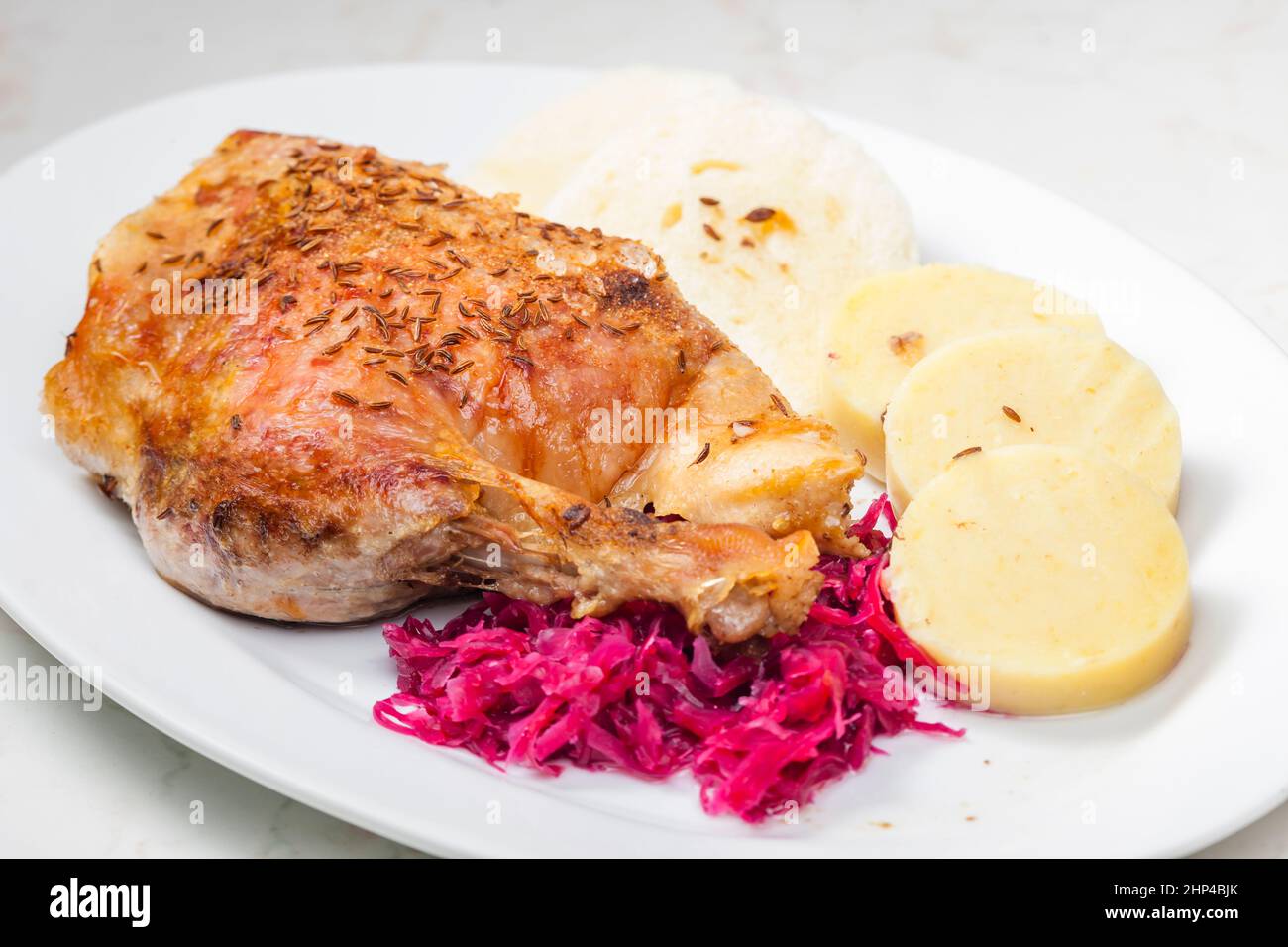 roasted goose leg with red cabbage and dumplings Stock Photo - Alamy