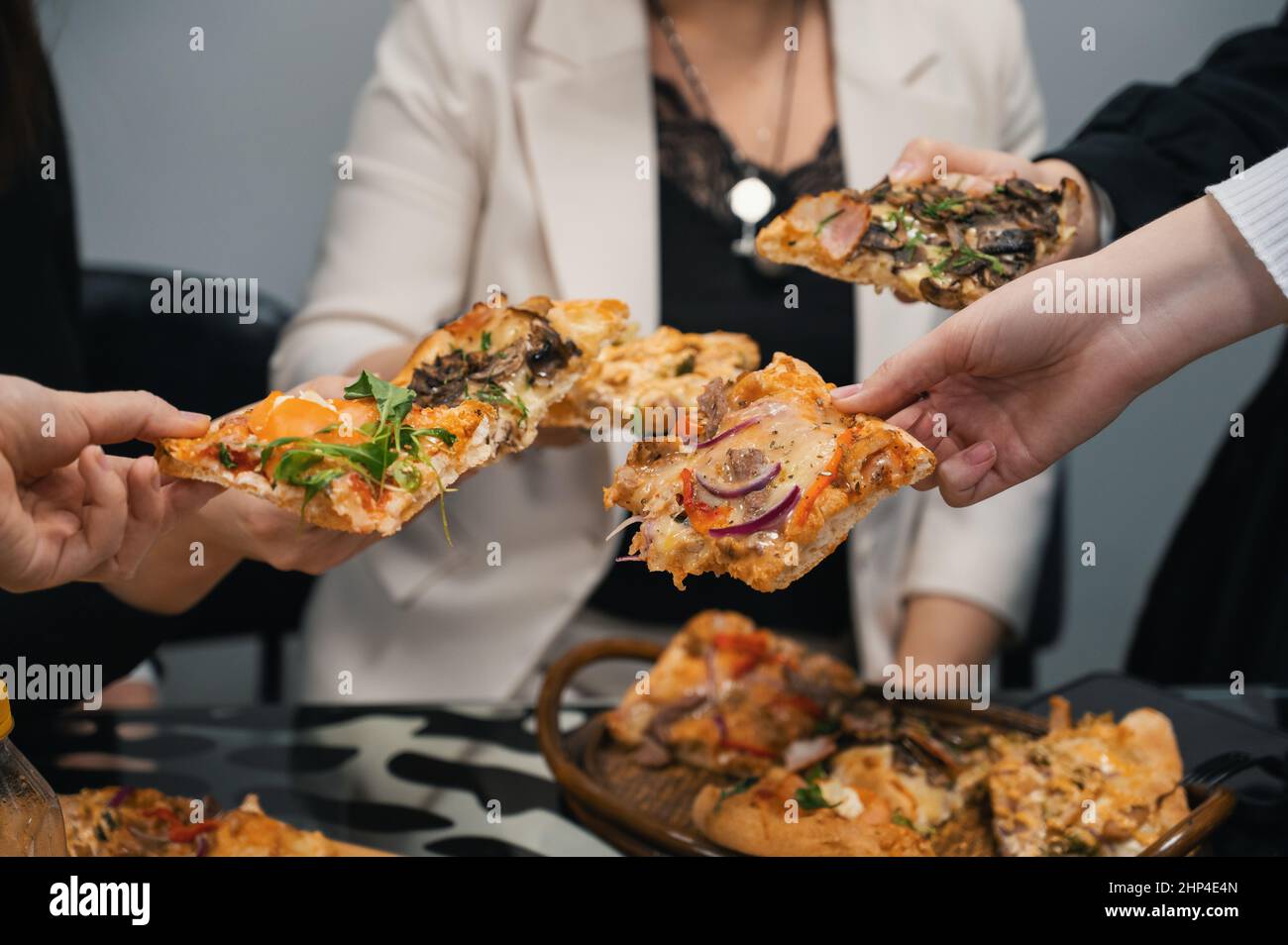 Team people eating pizza in office Stock Photo - Alamy