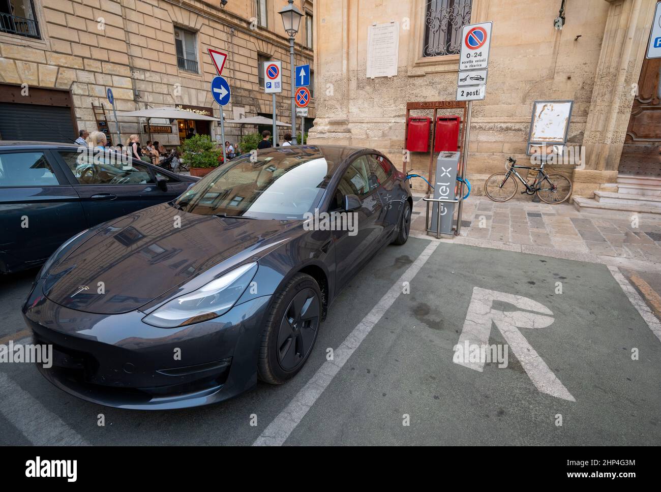 Lecce, Puglia, Italy. August 2021. Pan footage of a Tesla car being ...