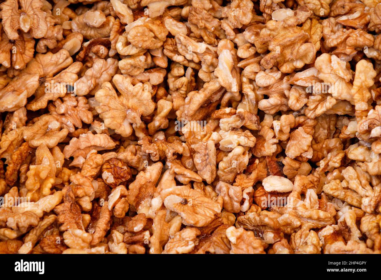 Raw walnuts outside of shell pile background pattern Stock Photo - Alamy