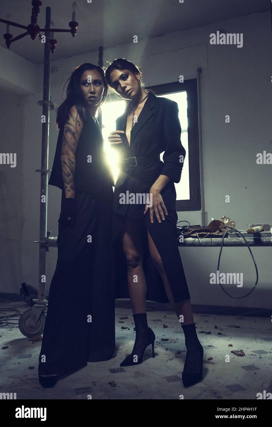 Two women wear elegant fashion clothes posing indoor. Fashion and ...