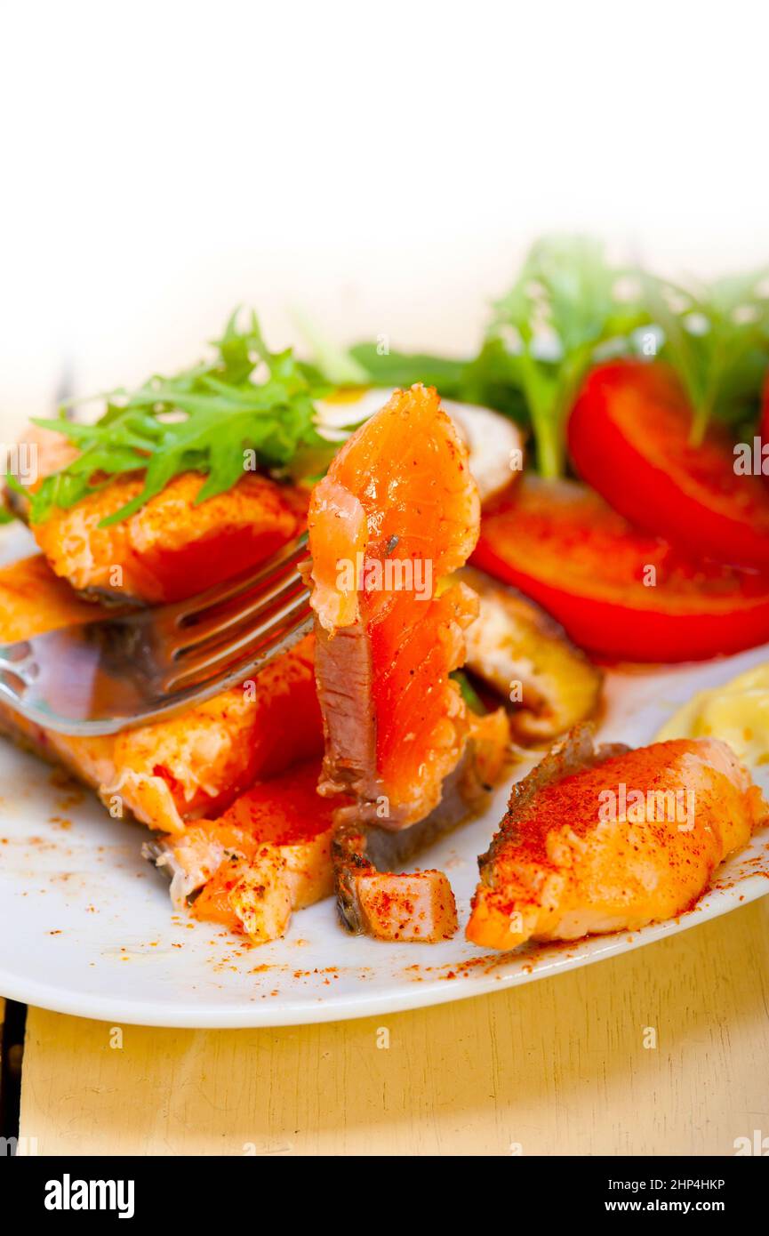 grilled fresh samon filet with vegetables salad tomato arugula ...