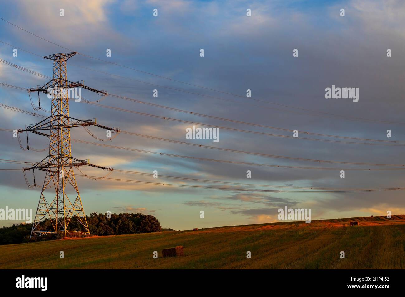 high voltage electric pylon with blue sky Stock Photo - Alamy