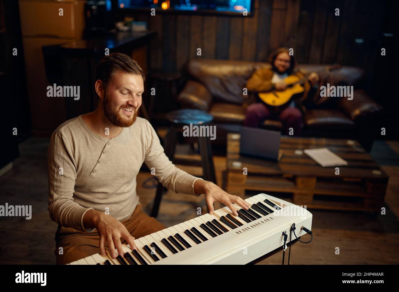 Happy friends musician enjoy creative hobby entertainment. Focus on guy ...