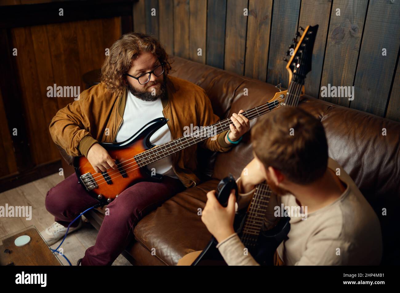 Young guy student listening while guitarist tutor composer playing ...