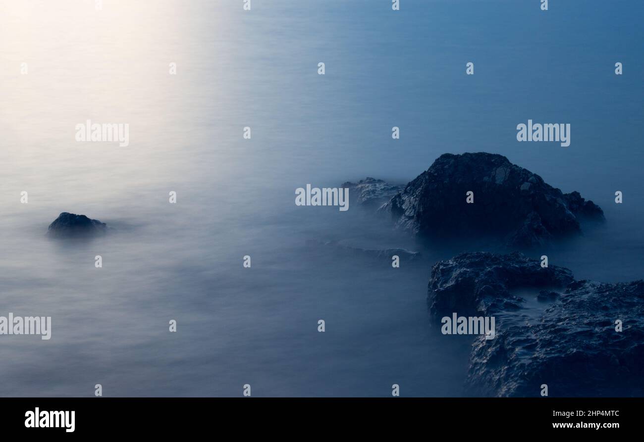 Rocks emerging from sea hi-res stock photography and images - Alamy