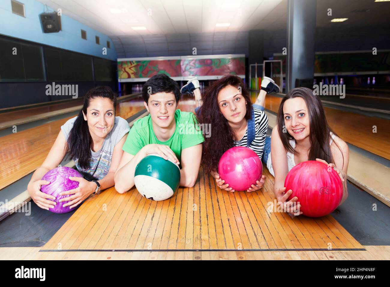 group of friends getting ready to play bowling Stock Photo - Alamy