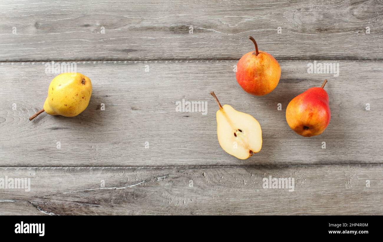 Table top view, ripe pears, one cut in half, on gray wood desk Stock ...