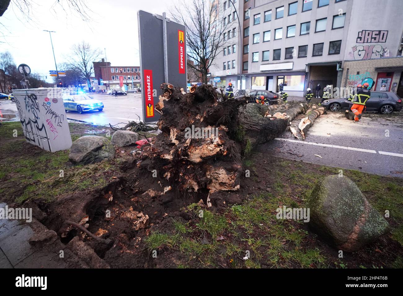 Hamburg, Germany. 18th Feb, 2022. Firefighters cut and transport a ...