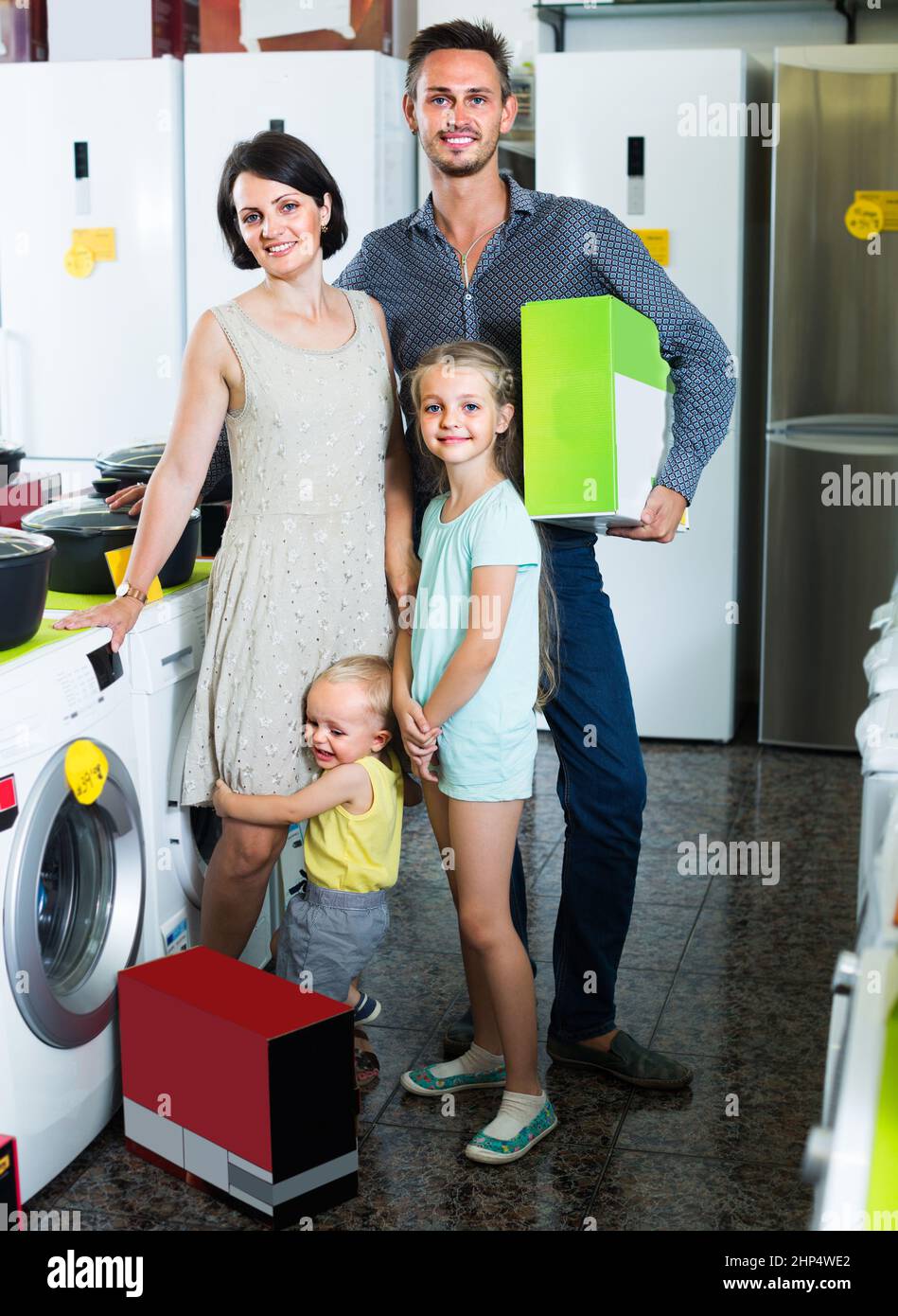 parents with kids in store Stock Photo - Alamy