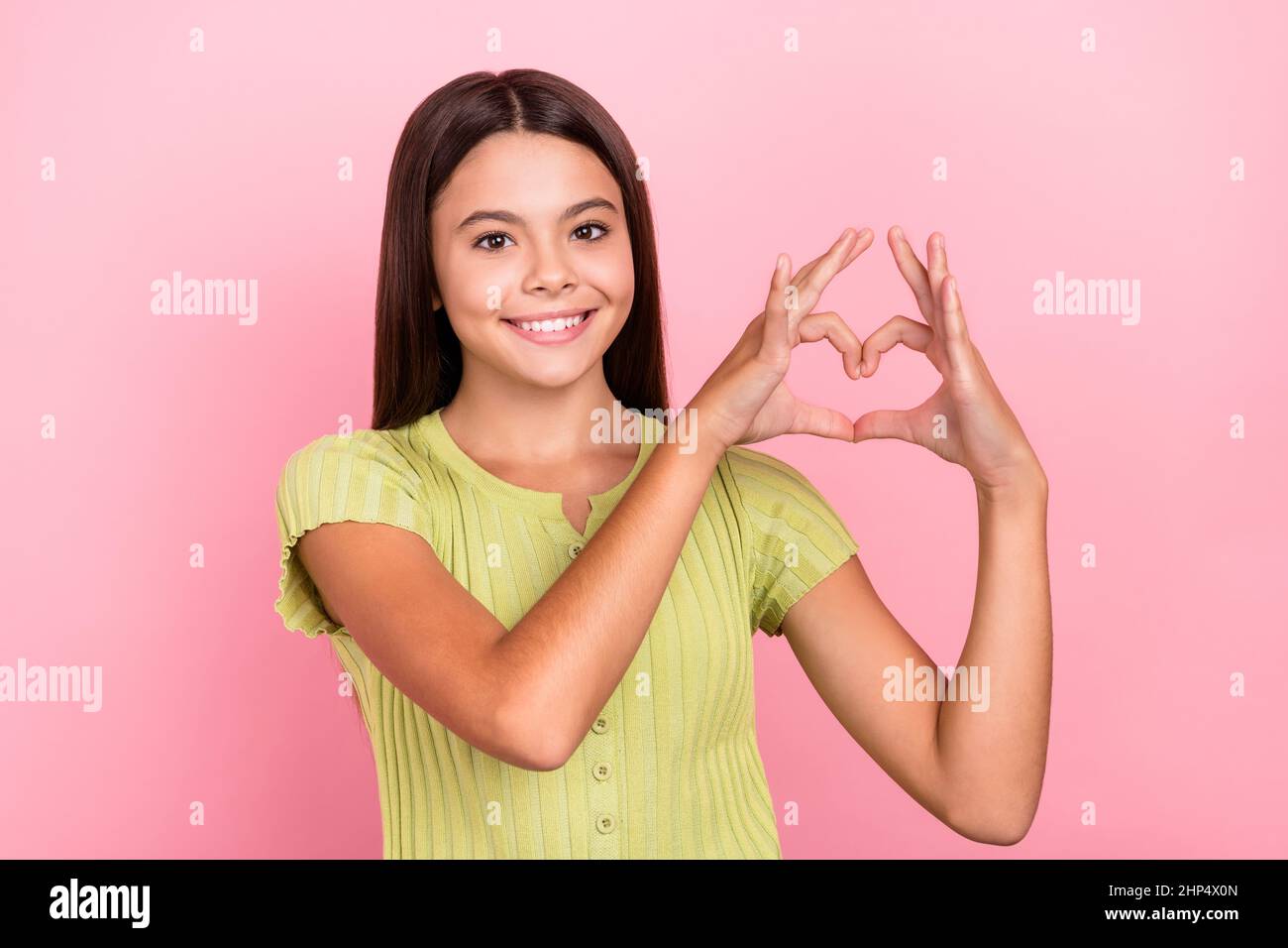 Photo of romantic affectionate lady fingers show heart symbol wear ...