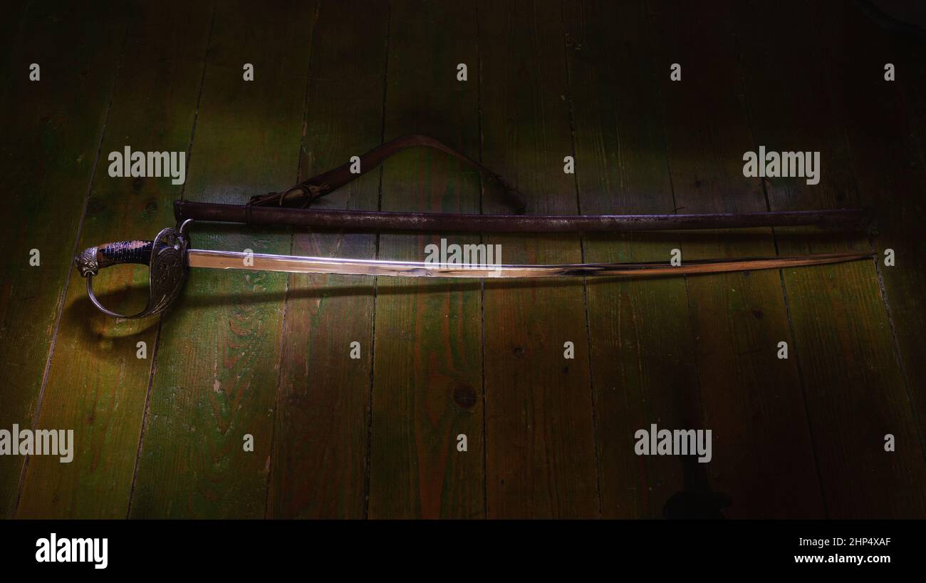 Old rusty sword on wooden green floor Stock Photo - Alamy
