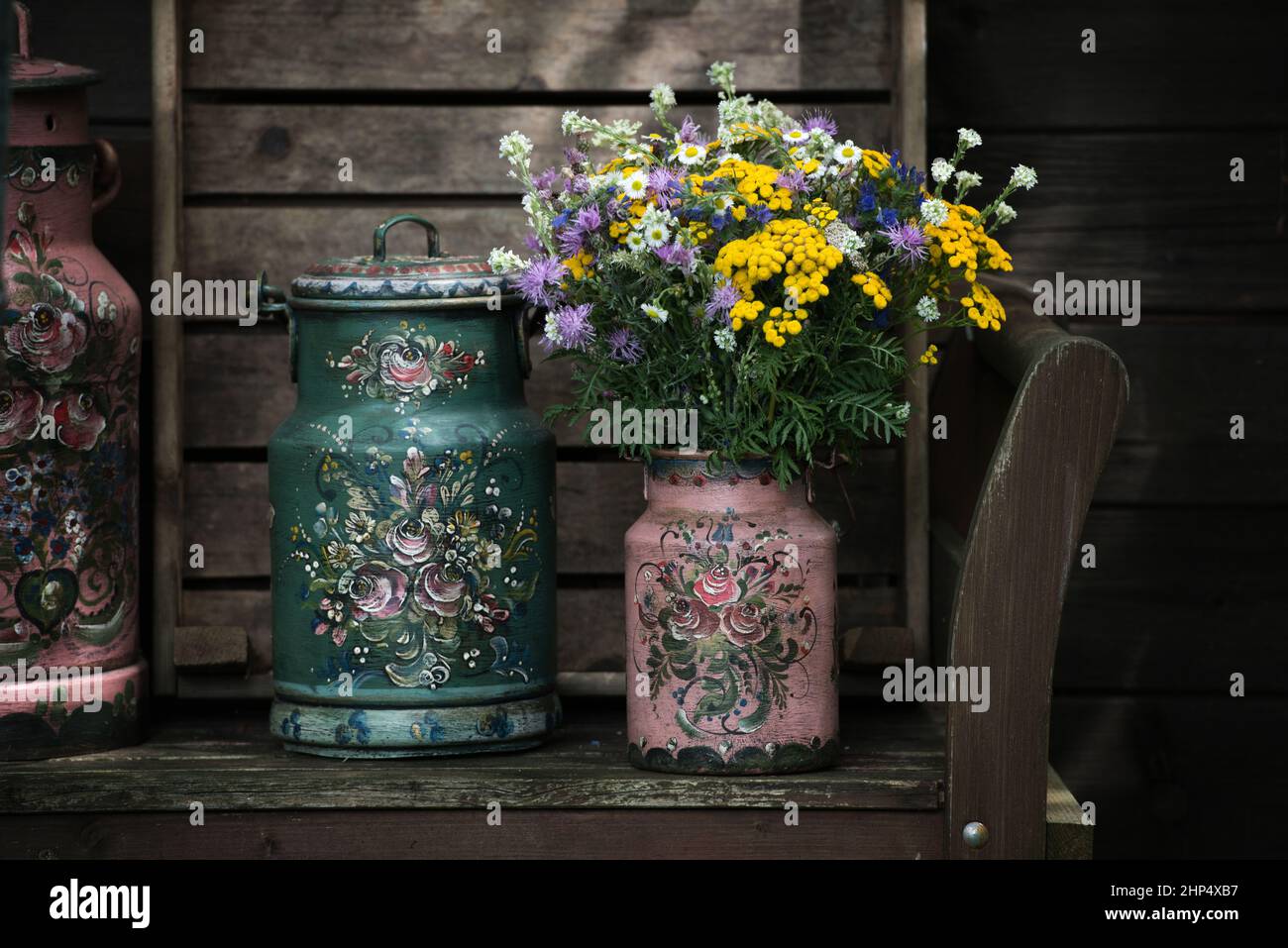 Old milk jugs on a garden bench Stock Photo - Alamy