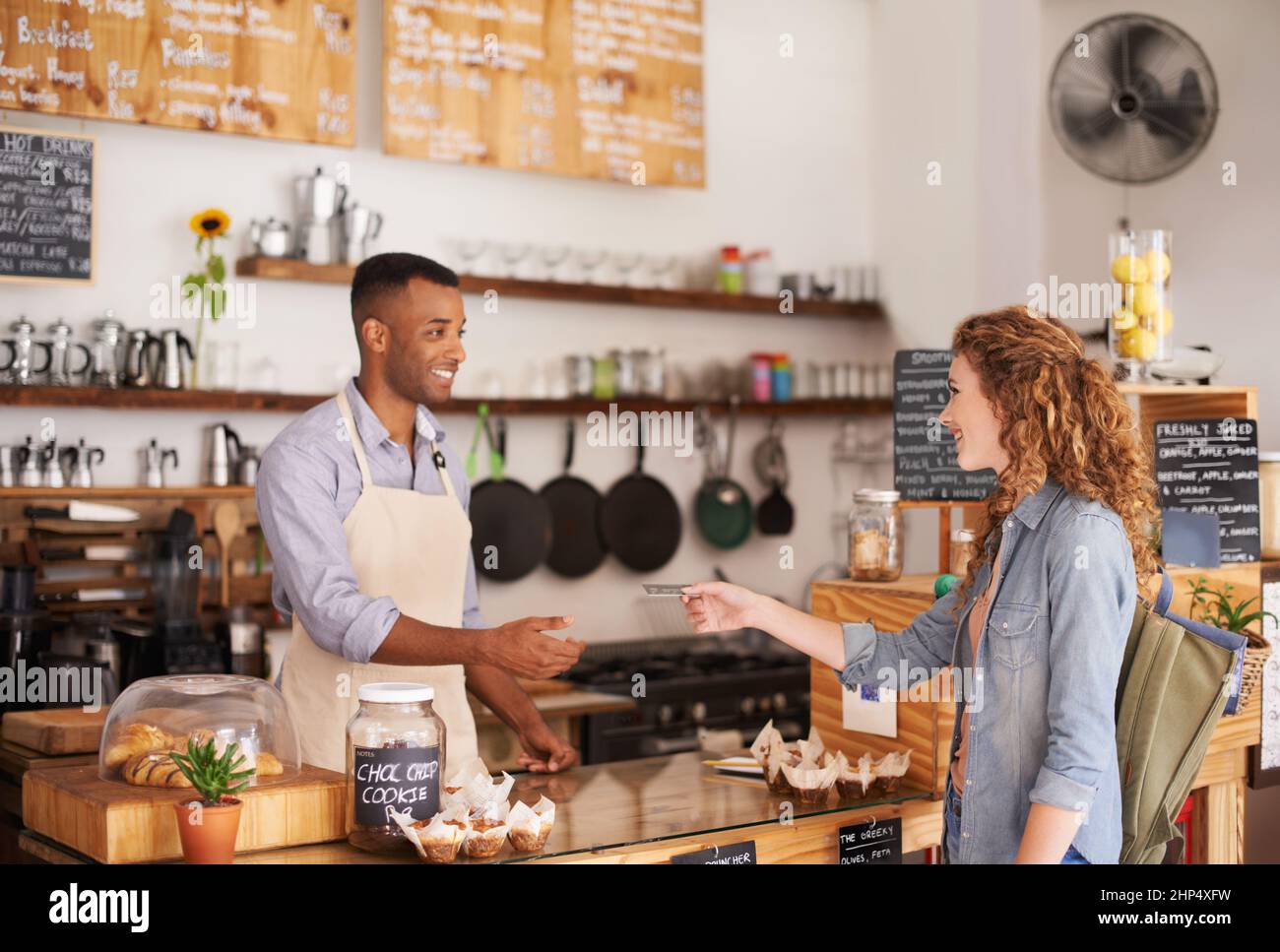 The coolest cafe in town. Shot of two people in a cafe Stock Photo - Alamy