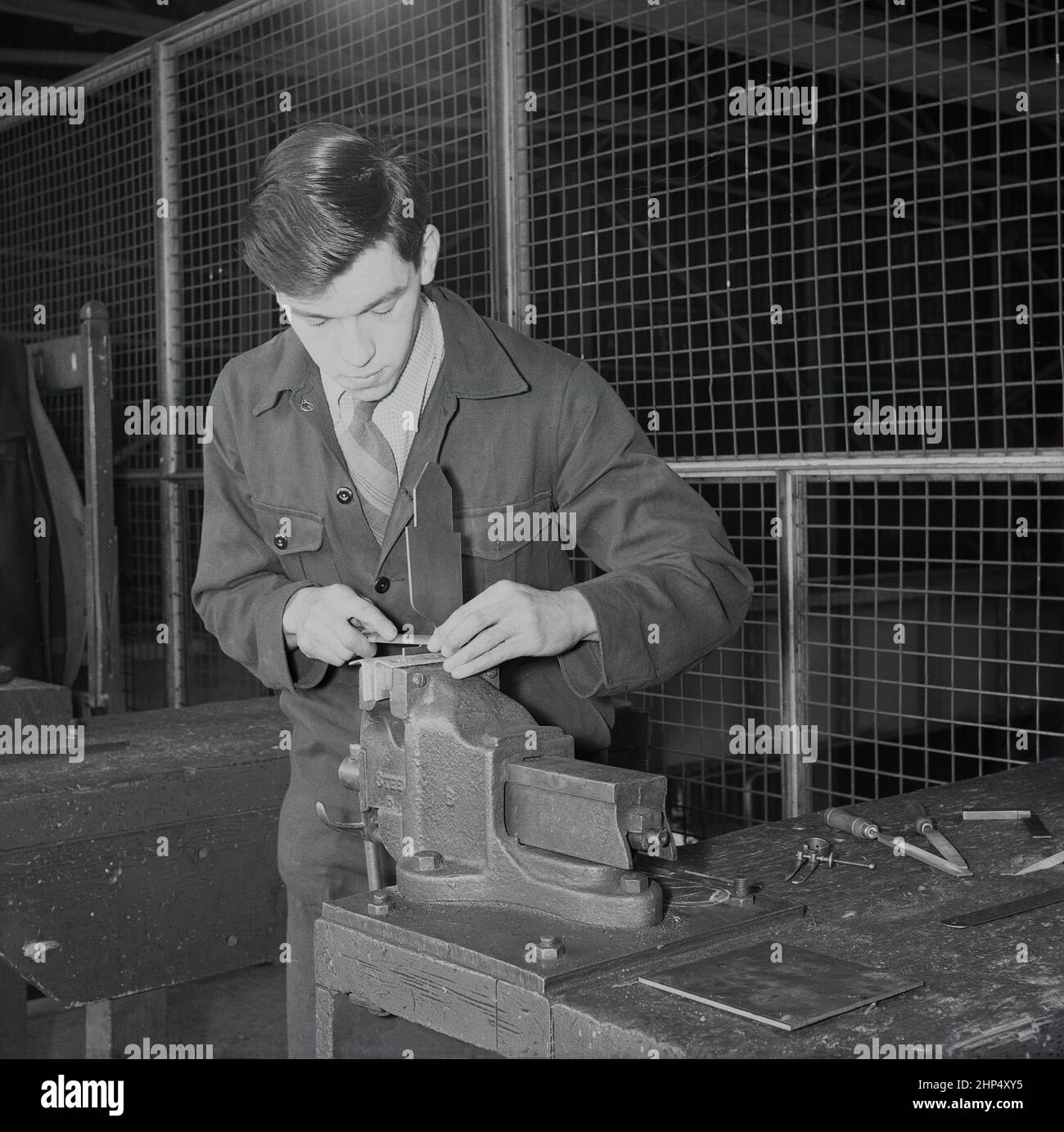 1950s, historical, a young male apprentice in a shirt and tie and ...