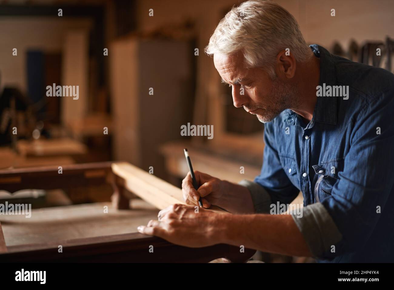 Patience-use it before you lose it. Cropped shot of a mature carpenter ...