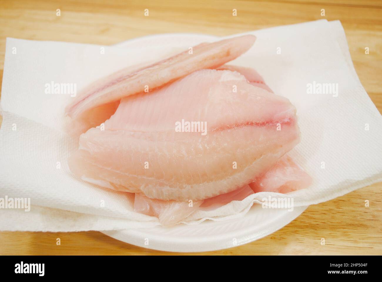 Raw Mild White Fish Drying on White Paper Towel Stock Photo - Alamy
