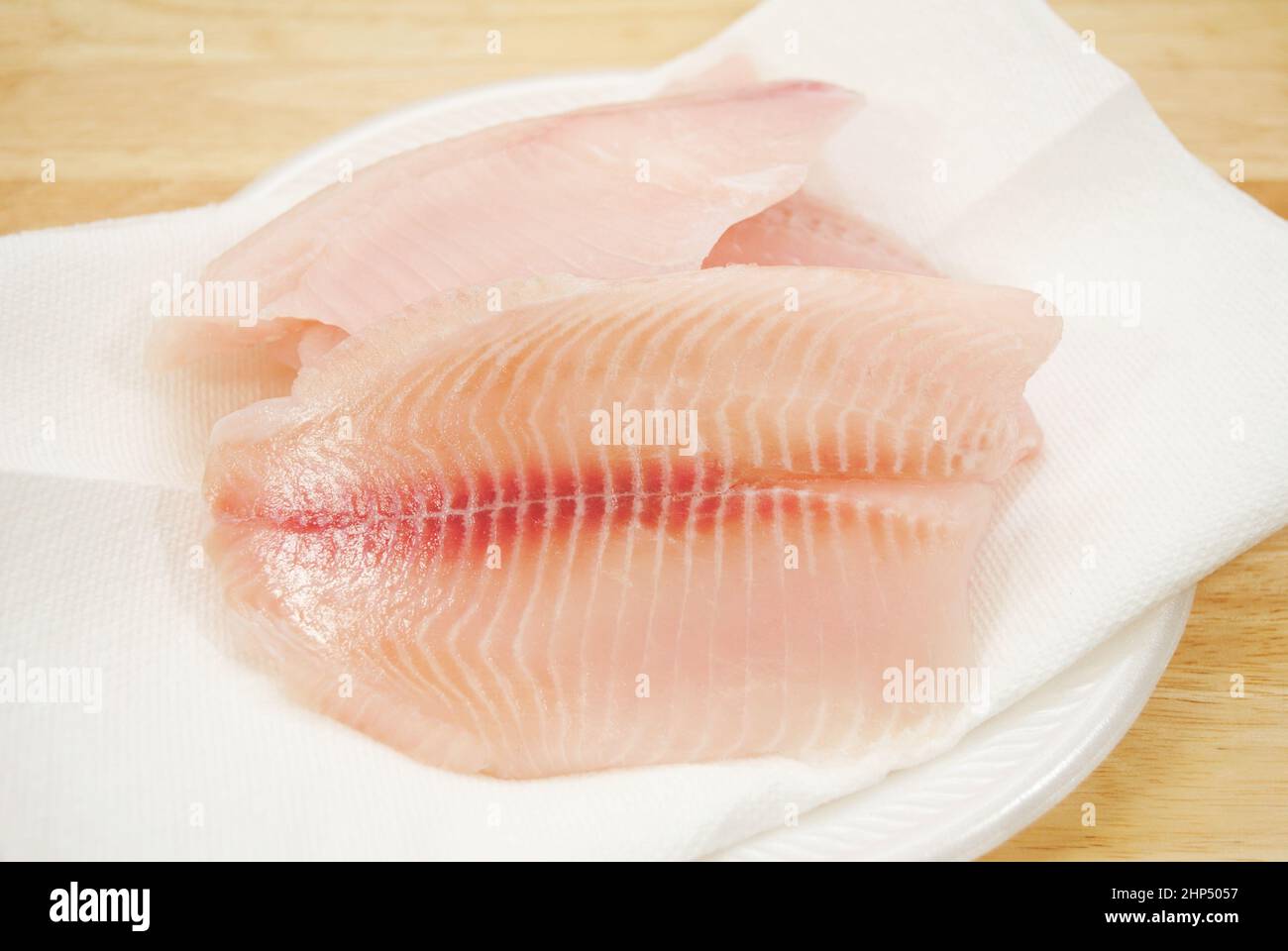 Raw Mild White Fish Drying on White Paper Towel Stock Photo - Alamy