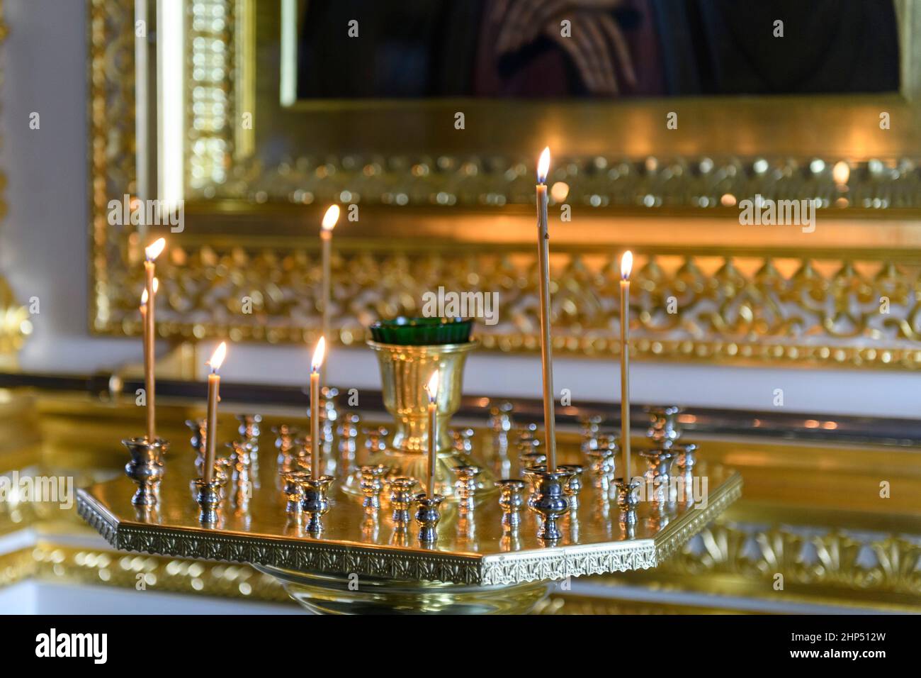 Church candles on the background of icons in Russian orthodox cathedral ...