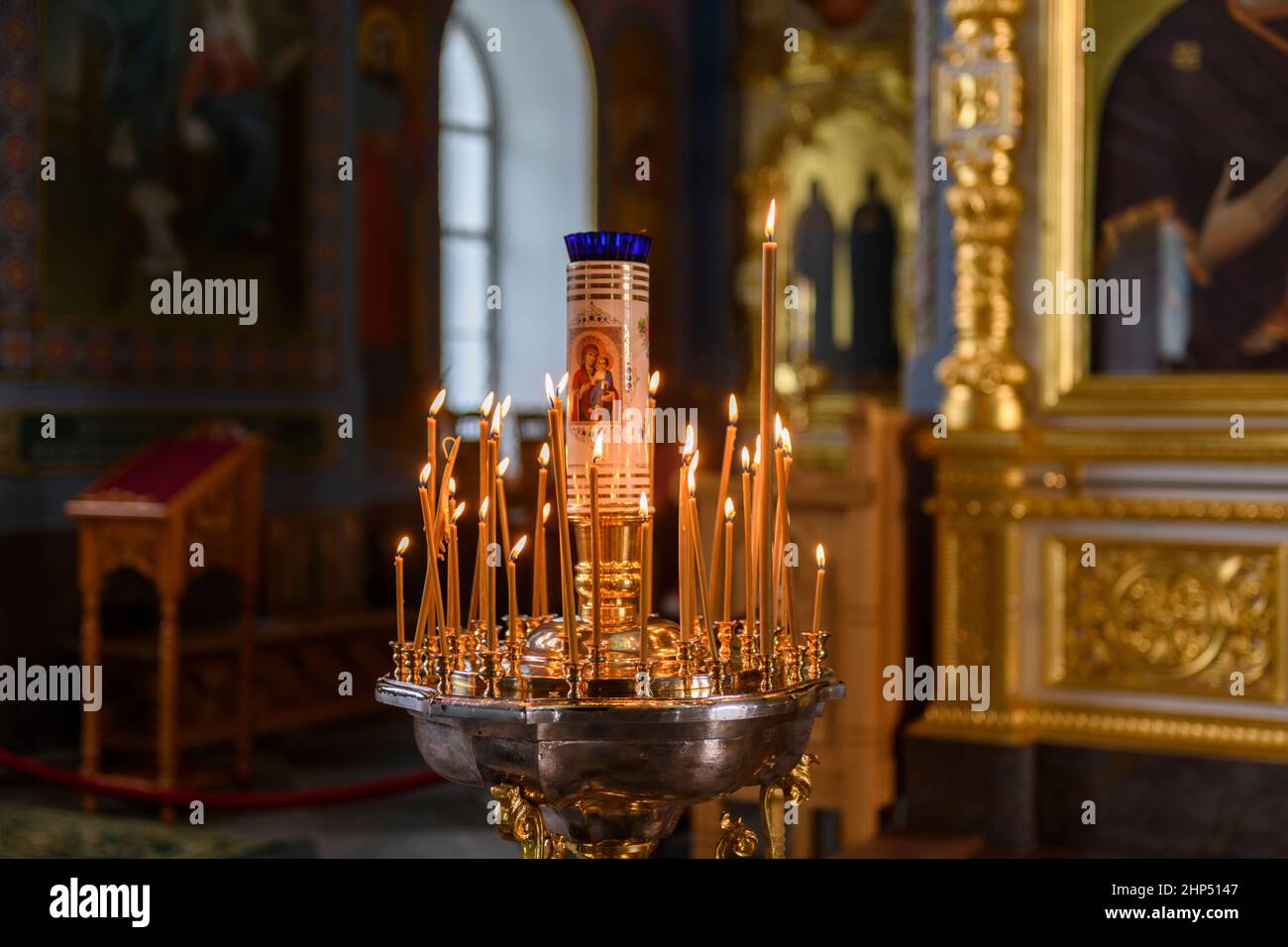 Church candles on the background of icons in Russian orthodox cathedral ...