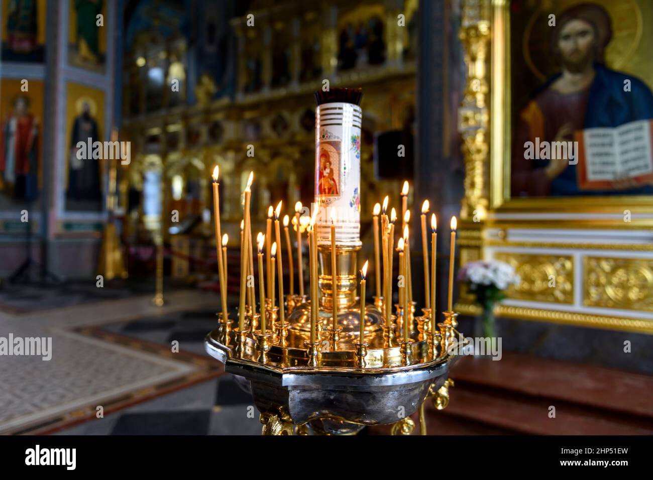 Church candles on the background of icons in Russian orthodox cathedral ...