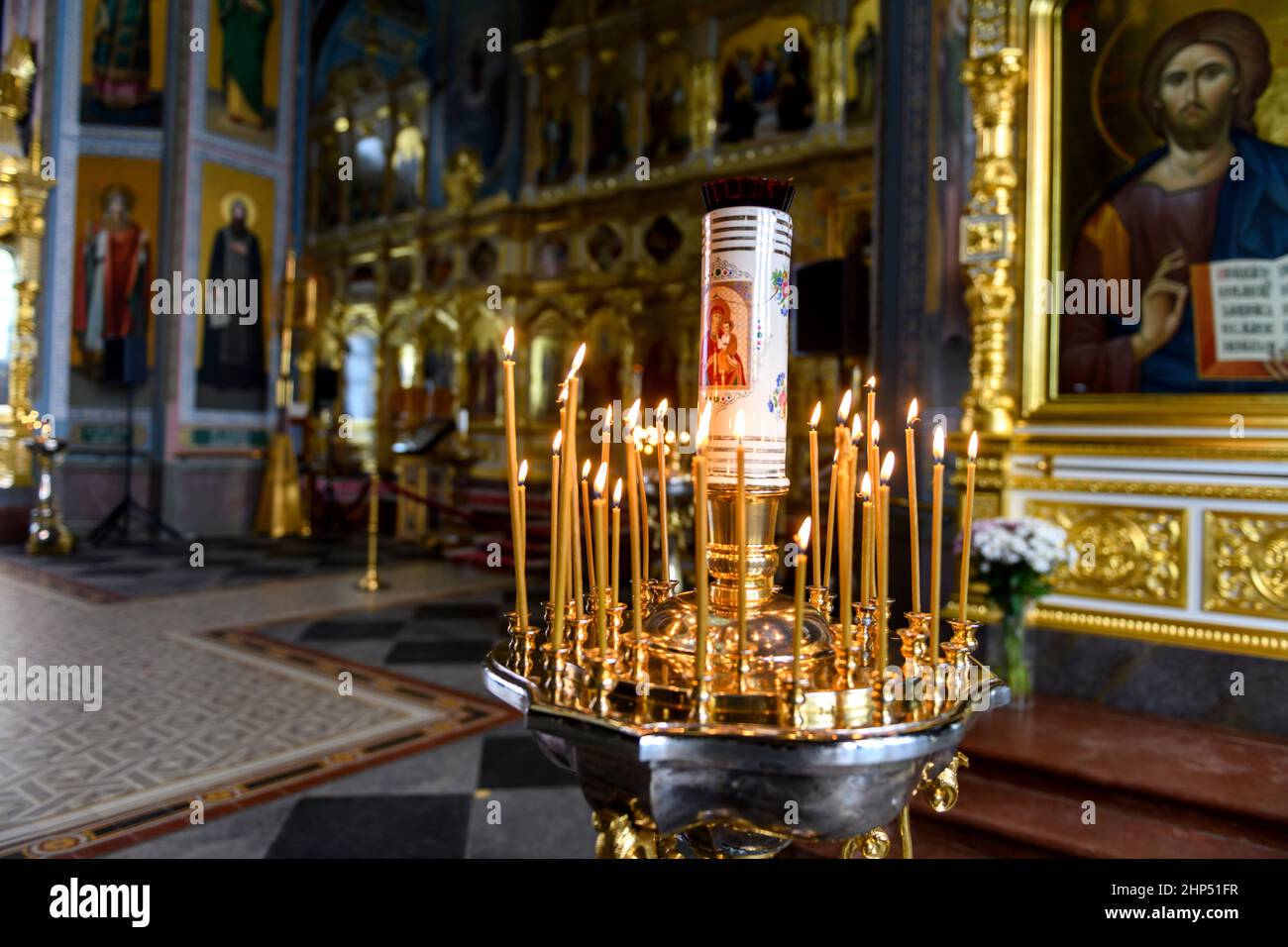 Church candles on the background of icons in Russian orthodox cathedral ...