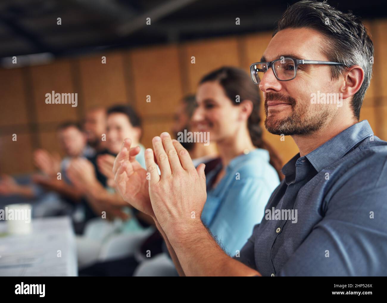 The creative process. Shot of a group of colleagues clapping together ...