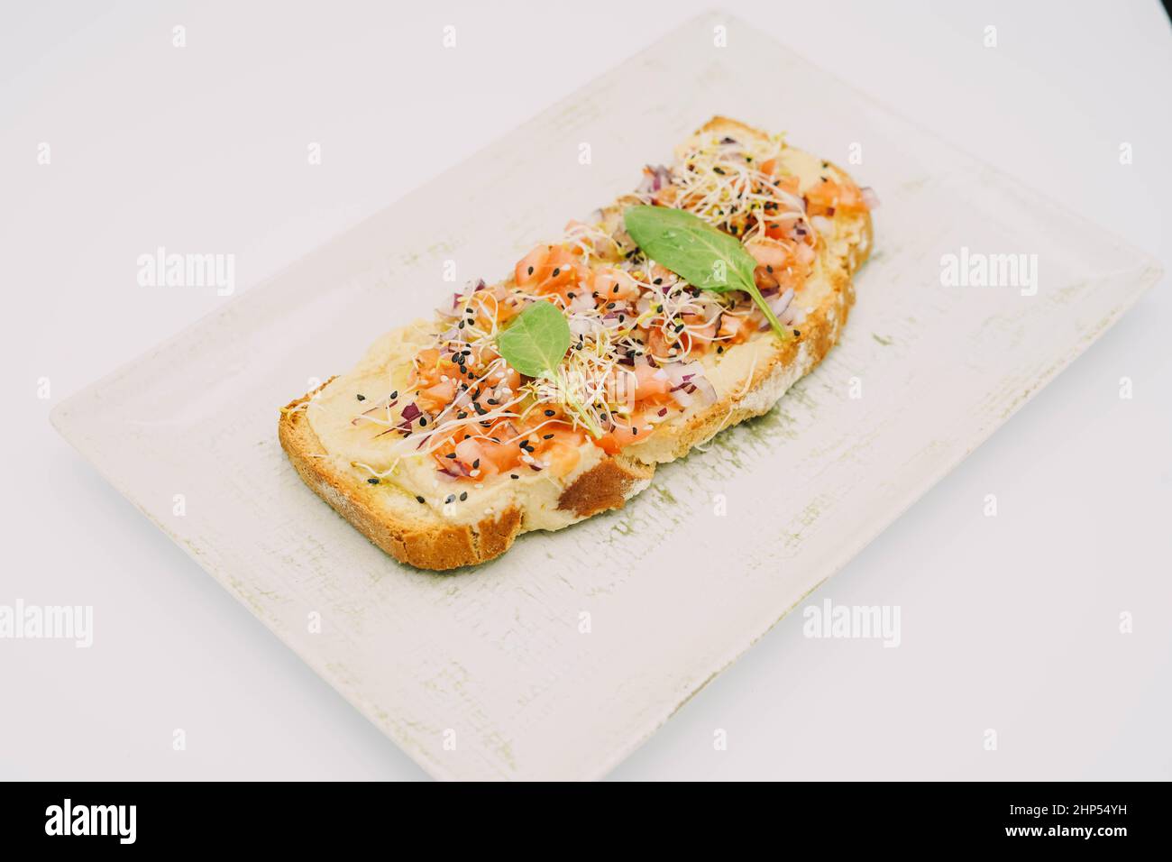 Tomato toast, onion, basil and spices Stock Photo - Alamy