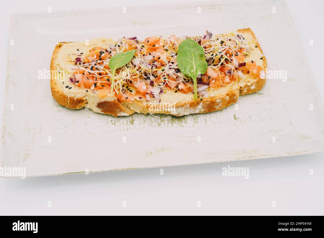 Tomato toast, onion, basil and spices Stock Photo - Alamy