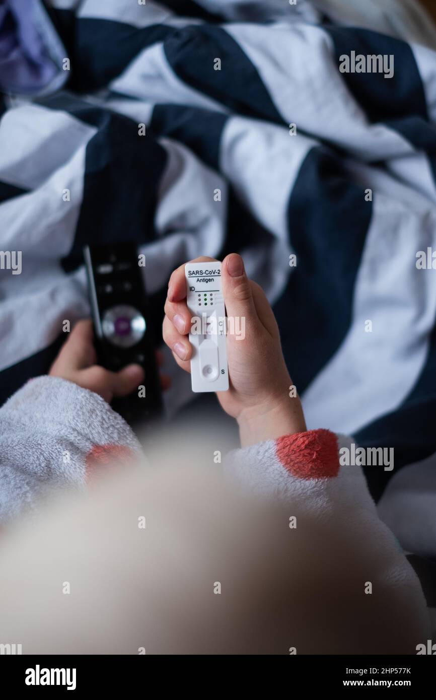 Child testing herself for coronavirus at home. Positive rapid COVID-19 ...