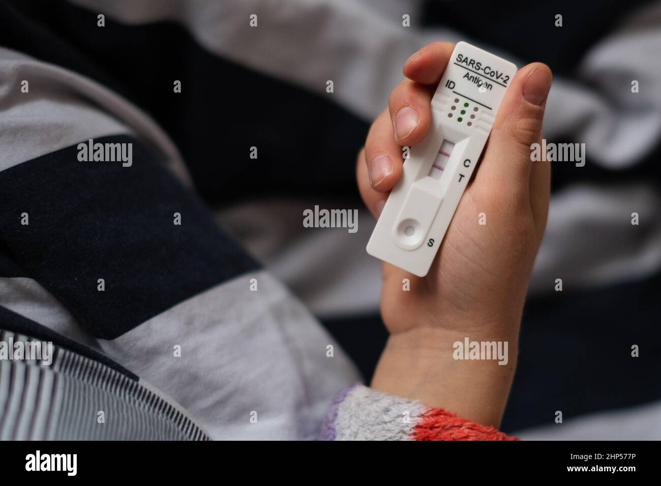 Child testing herself for coronavirus at home. Positive rapid COVID-19 ...