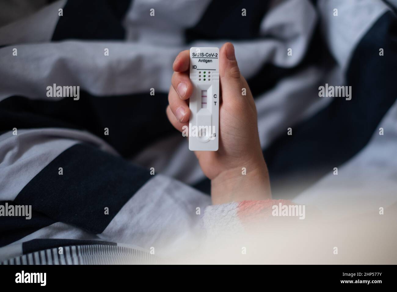 Child testing herself for coronavirus at home. Positive rapid COVID-19 ...