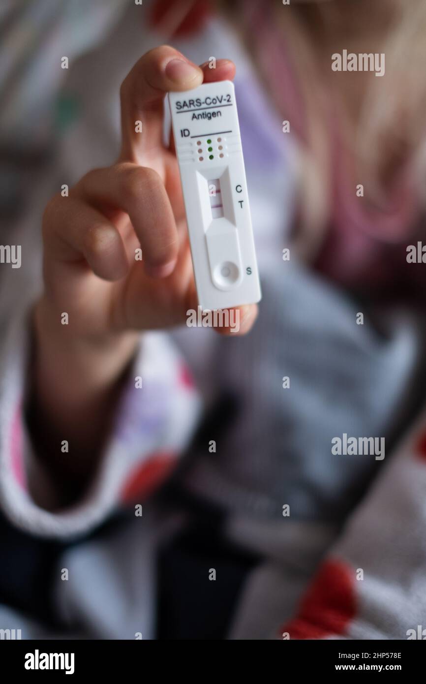 Child testing herself for coronavirus at home. Positive rapid COVID-19 ...
