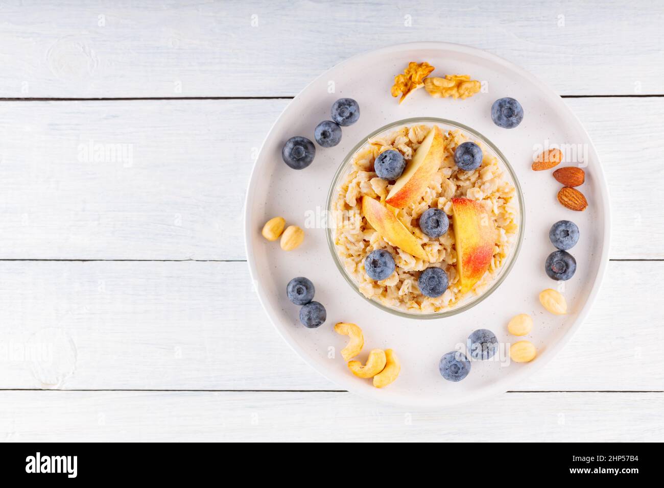 Bowl of oatmeal porridge with berries and slices of apples. Healthy ...