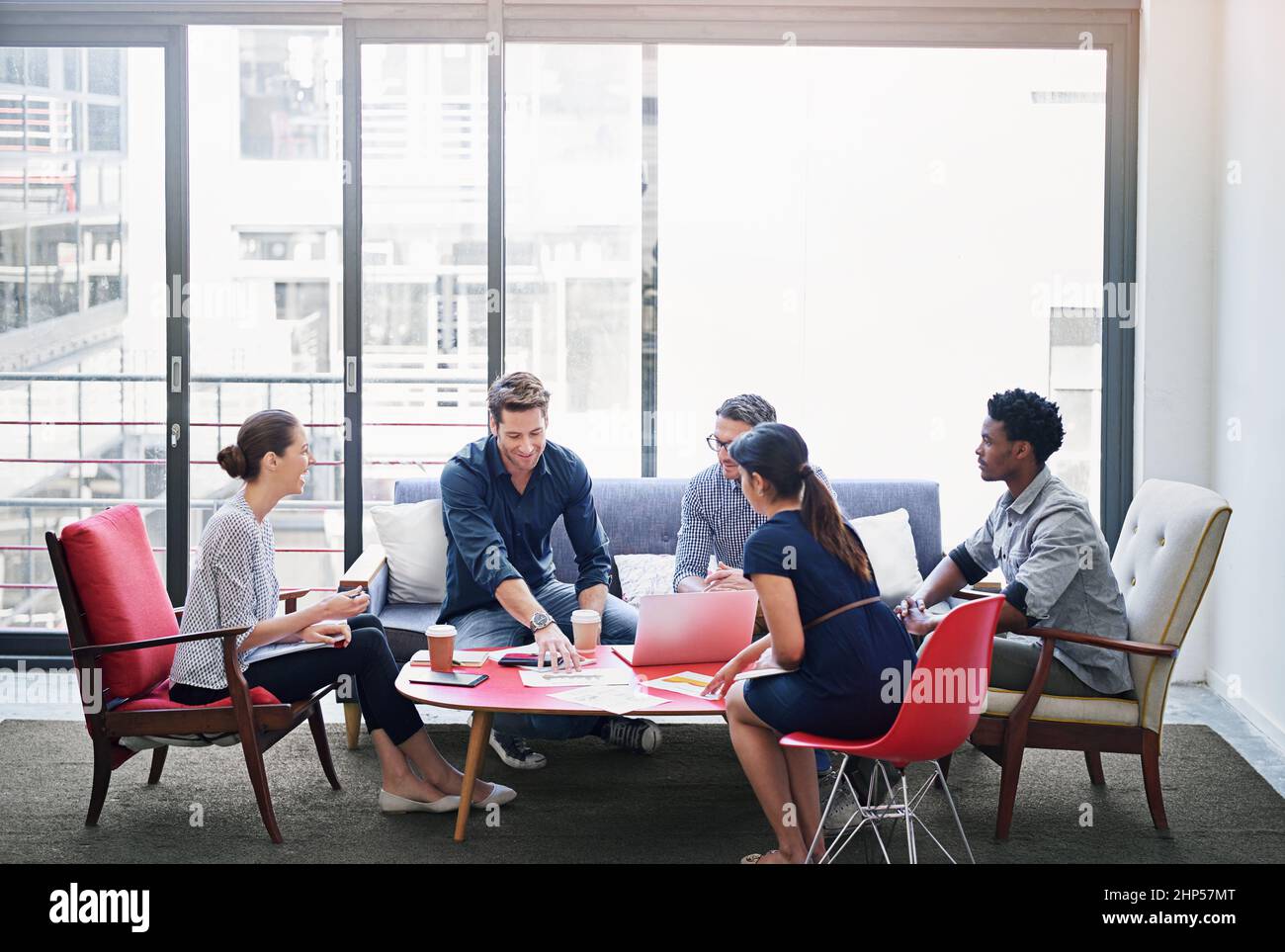 Their space for ideas. Shot of a group of coworkers in a meeting in an ...