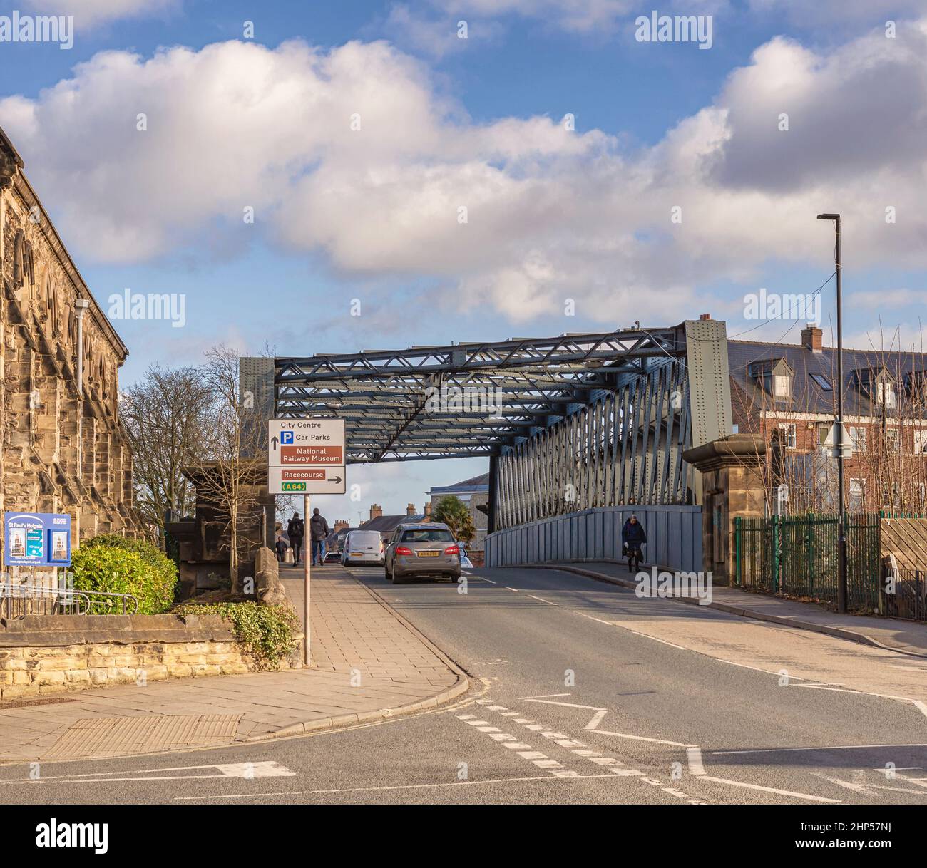 An iron road bridge, completed in 1911, over a railway. Cars and ...