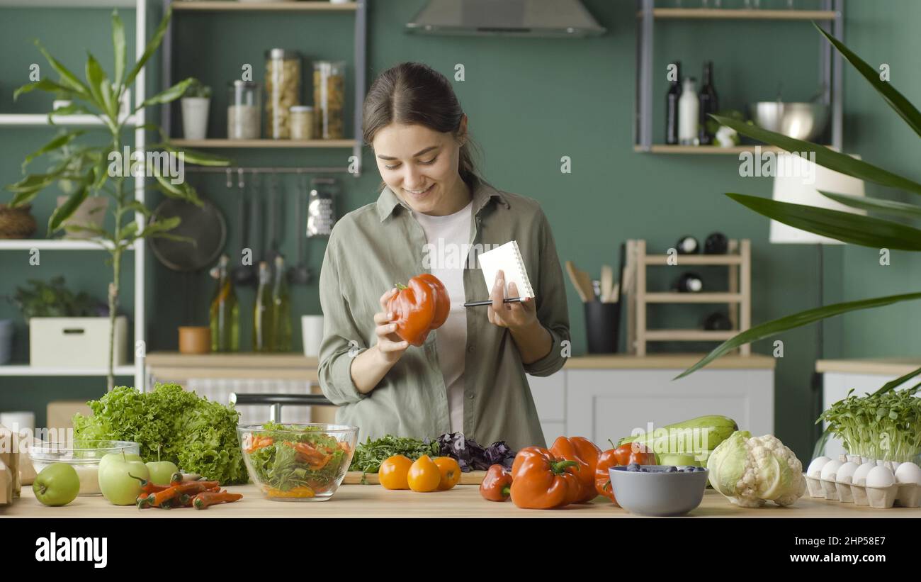Young Woman Makes a Diet Plan of Correct Nutrition, Counts Calories ...