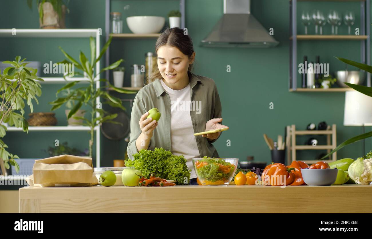 Young Woman Makes a Diet Plan of Correct Nutrition, Counts Calories ...