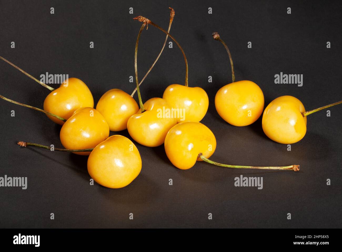 yellow cherry on black background Stock Photo - Alamy