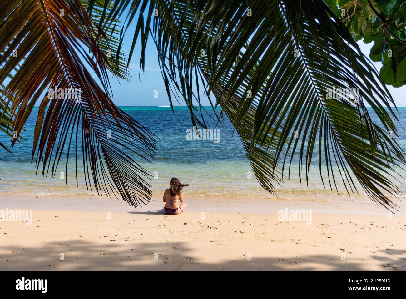 Woman wearing a two-piece swimsuit resting at a beach under the ...