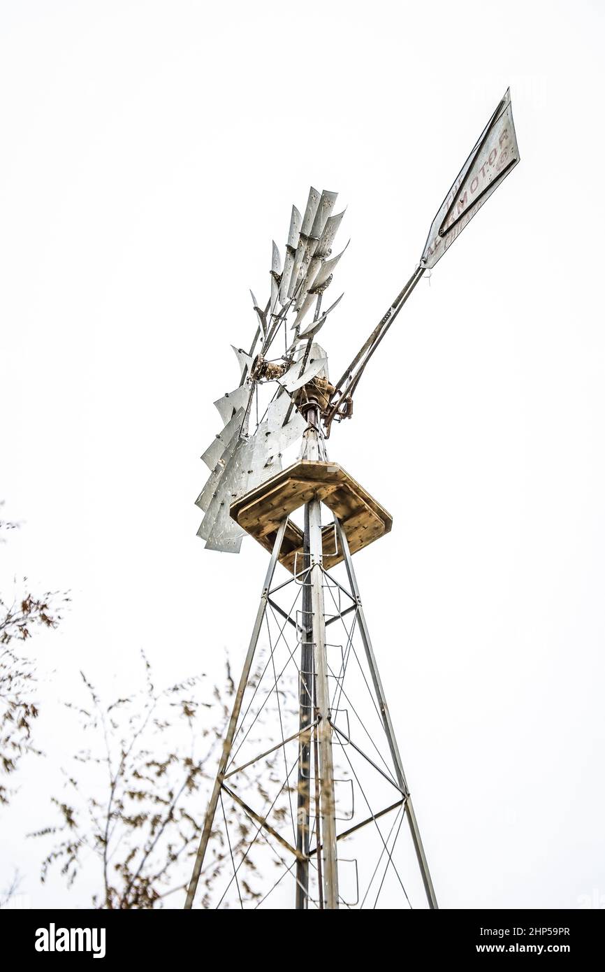 Low angle shot of a wind mill with trees Stock Photo - Alamy
