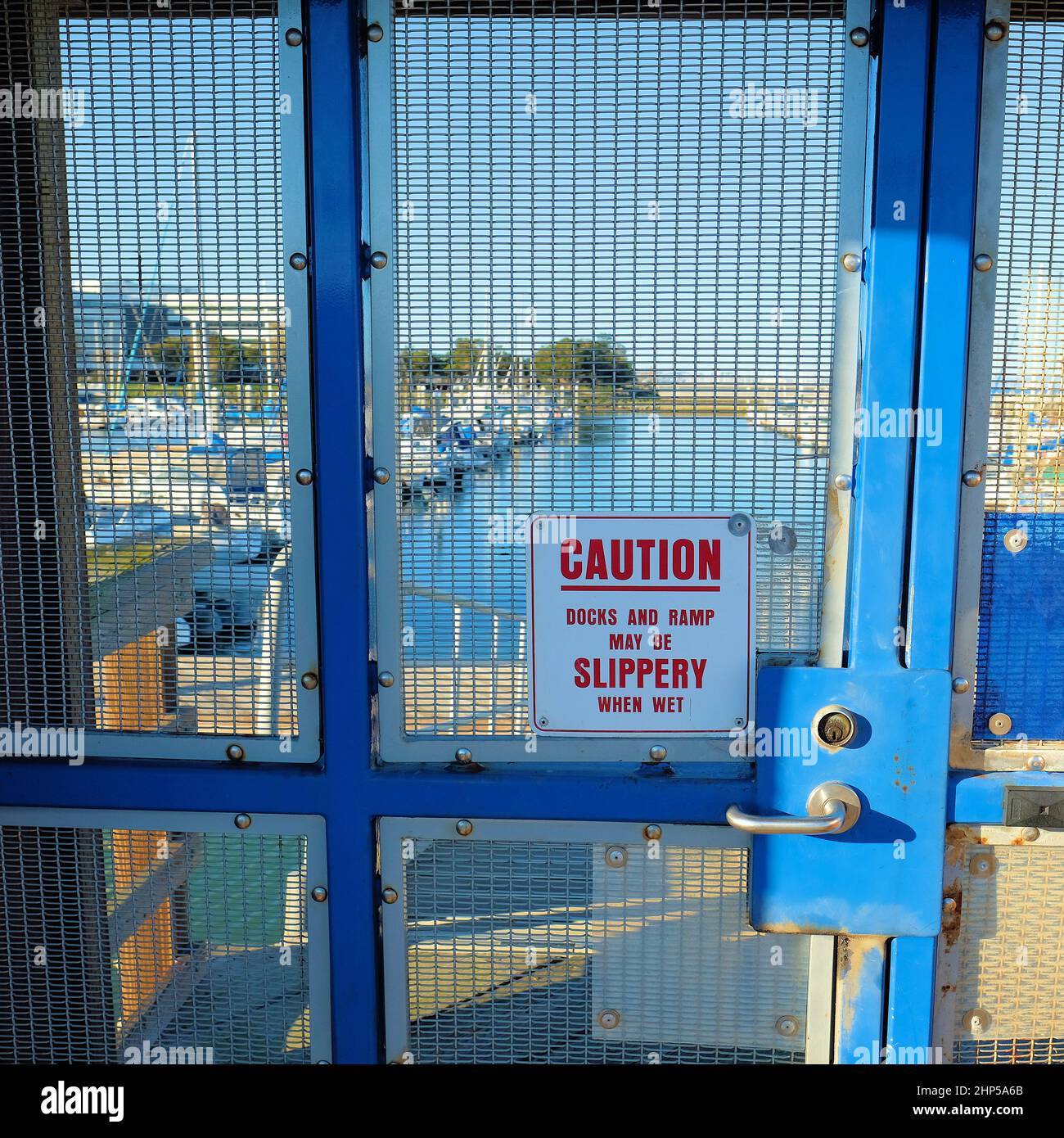 Caution Docks and Ramp May Be Slippery When Wet warning sign at the ...