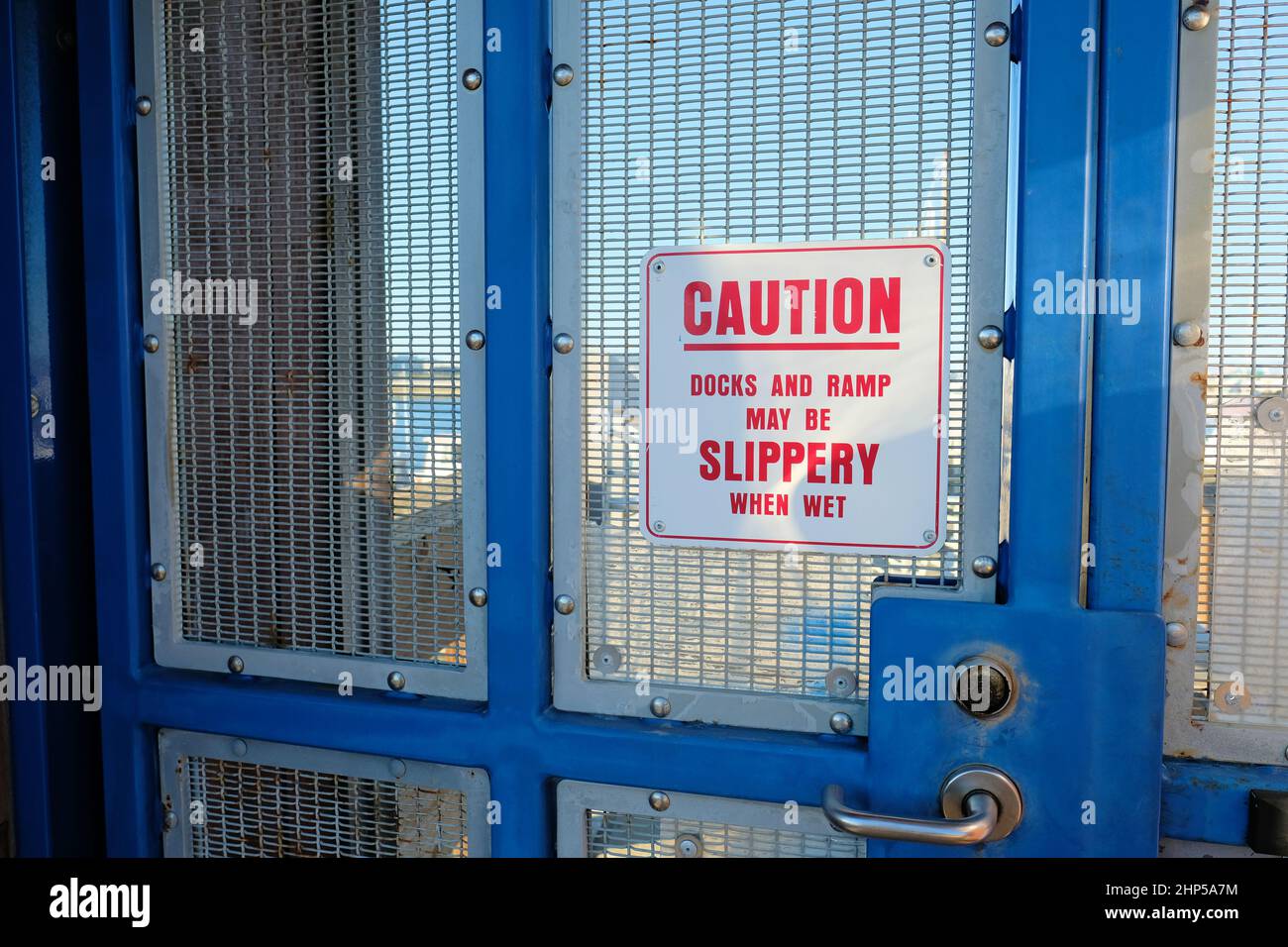 Caution Docks and Ramp May Be Slippery When Wet warning sign at the ...