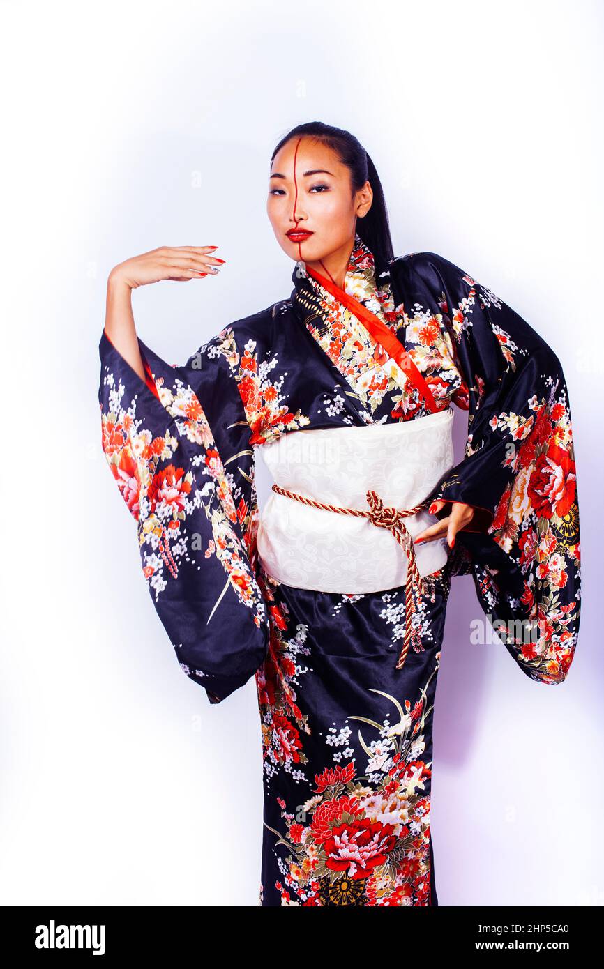 young pretty geisha in black kimono posing isolated on white background ...